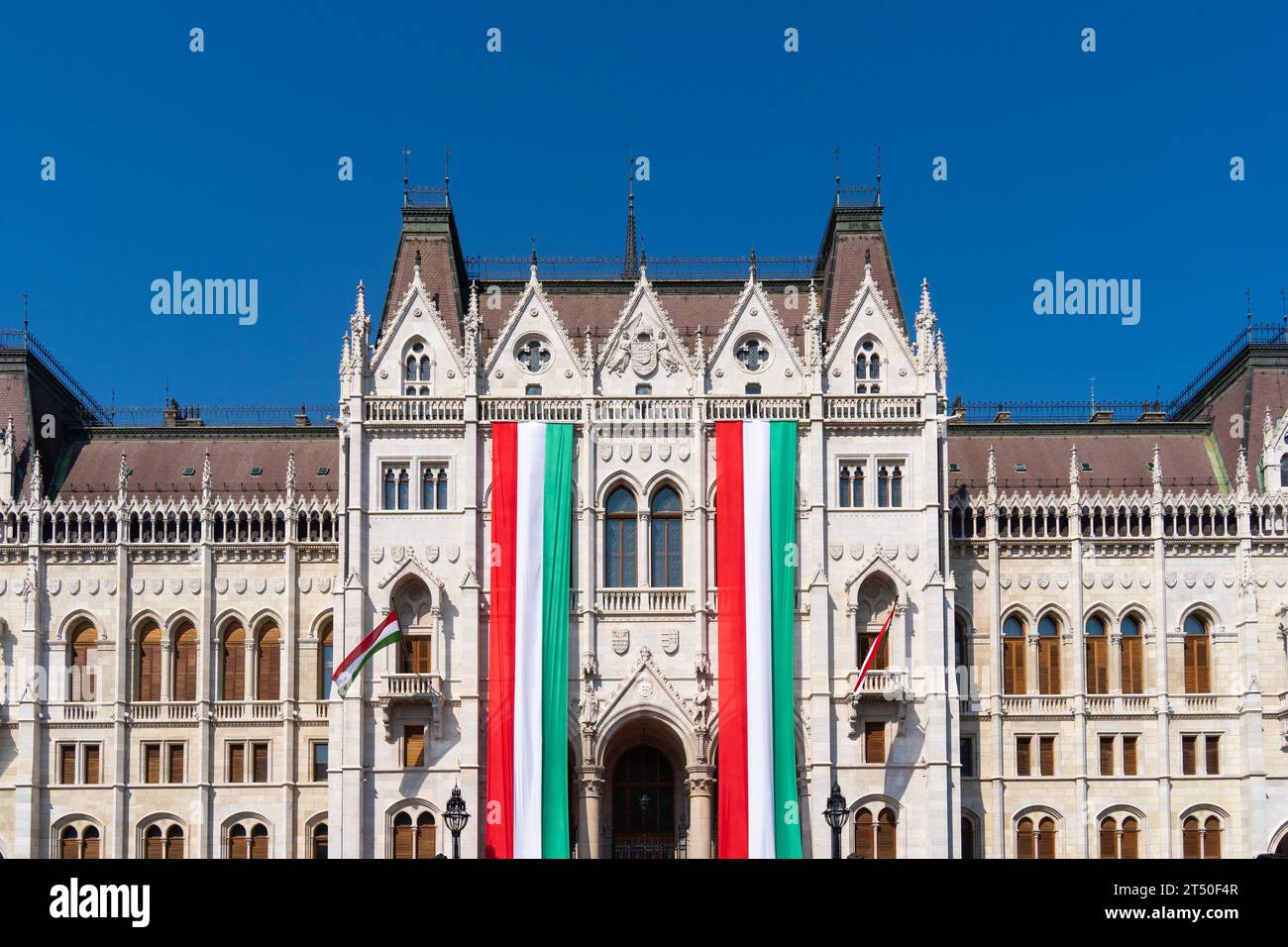 The neo-Gothic building of the Hungarian legislature, the Parliament, is decorated with flags in ...