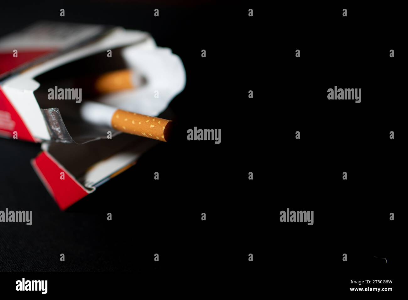 cigarette on the box black background Stock Photo - Alamy