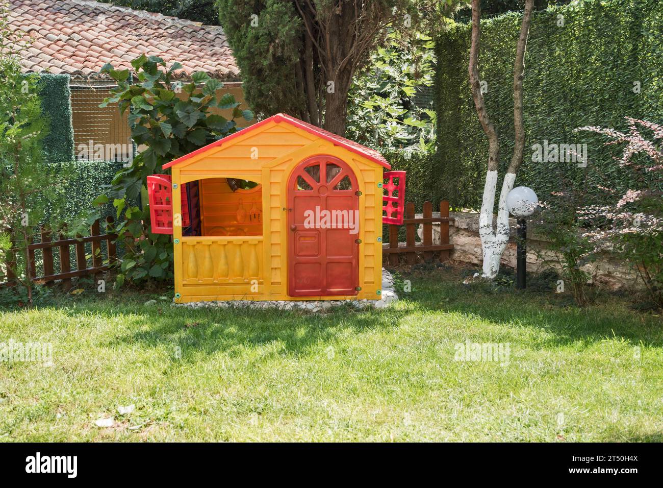 Colorful plastic children's house in garden backyard playhouse Stock ...