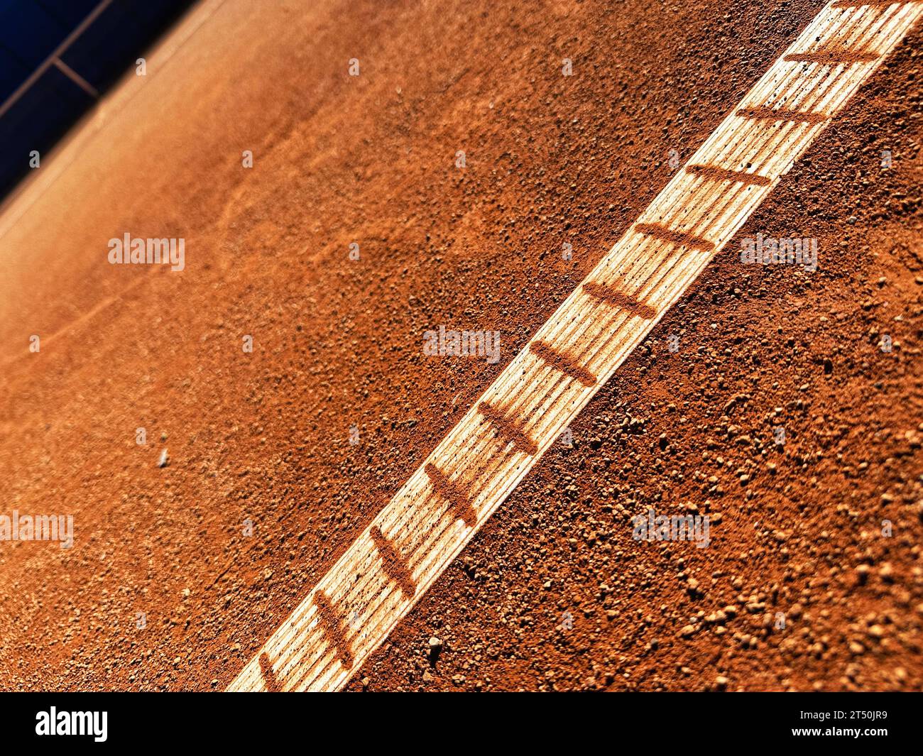 Unusual detailed view of white border line on orange clay tennis court ...