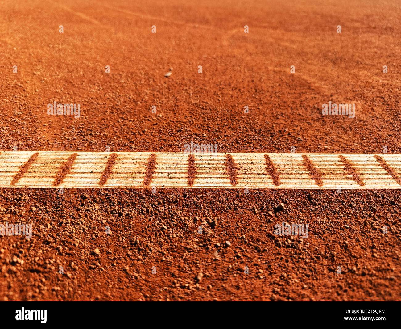 Closeup view of white line on orange clay tennis court. Traditional ...