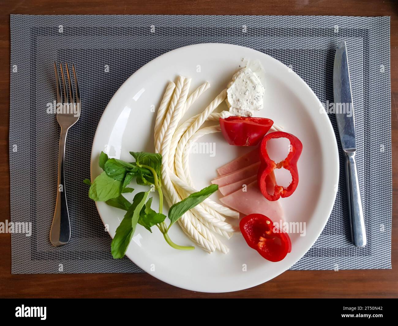 Turkish Helix String white Cheese with vegetables on plate with wooden ...