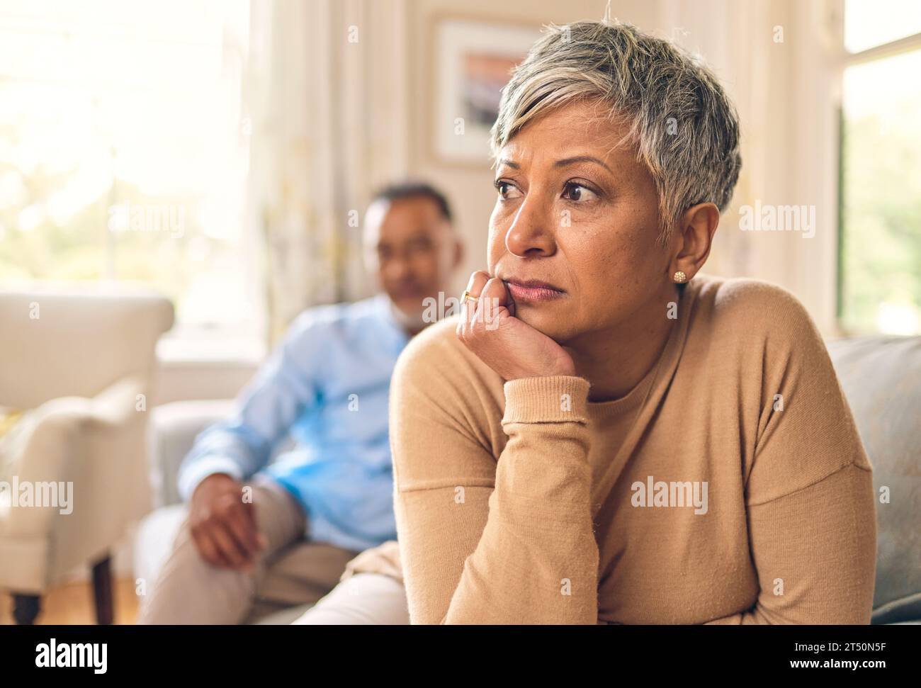 Divorce, fight and mature woman is sad in living room with partner at ...