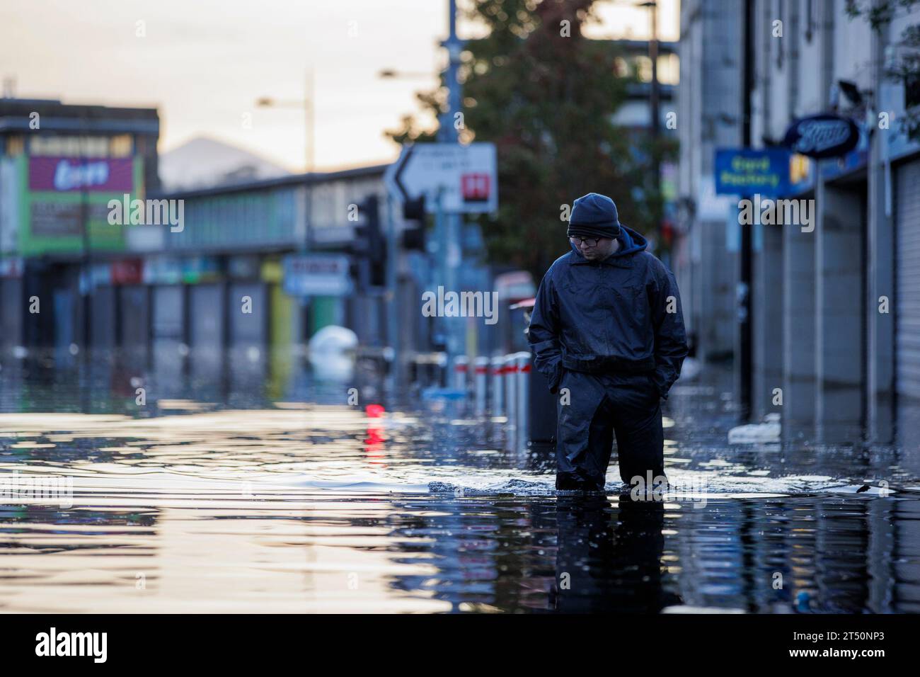 Michael McShane walks through flood water on Market Street in ...