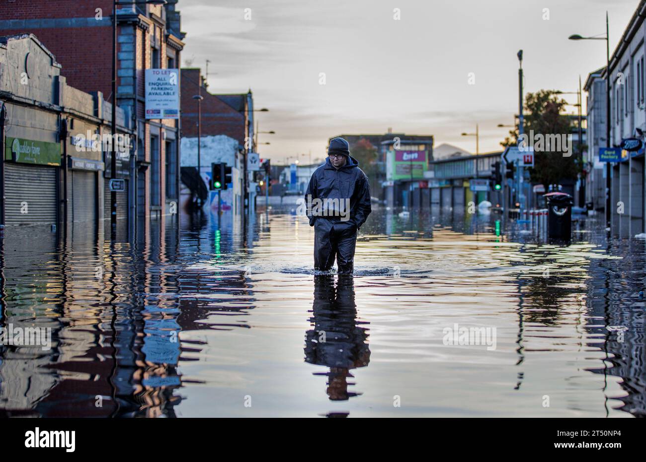 Michael McShane walks through flood water on Market Street in ...