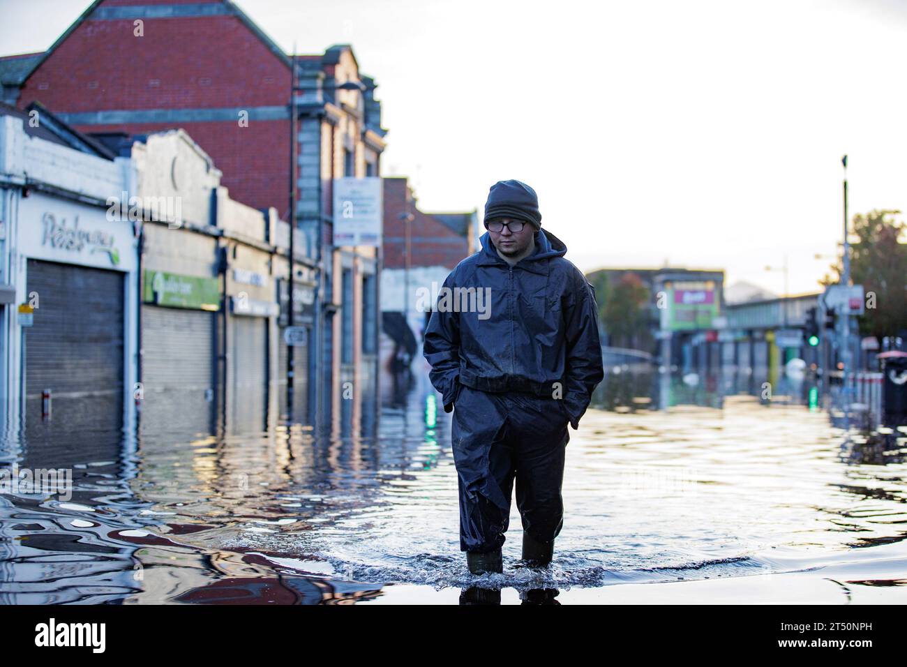 Michael McShane walks through flood water on Market Street in ...