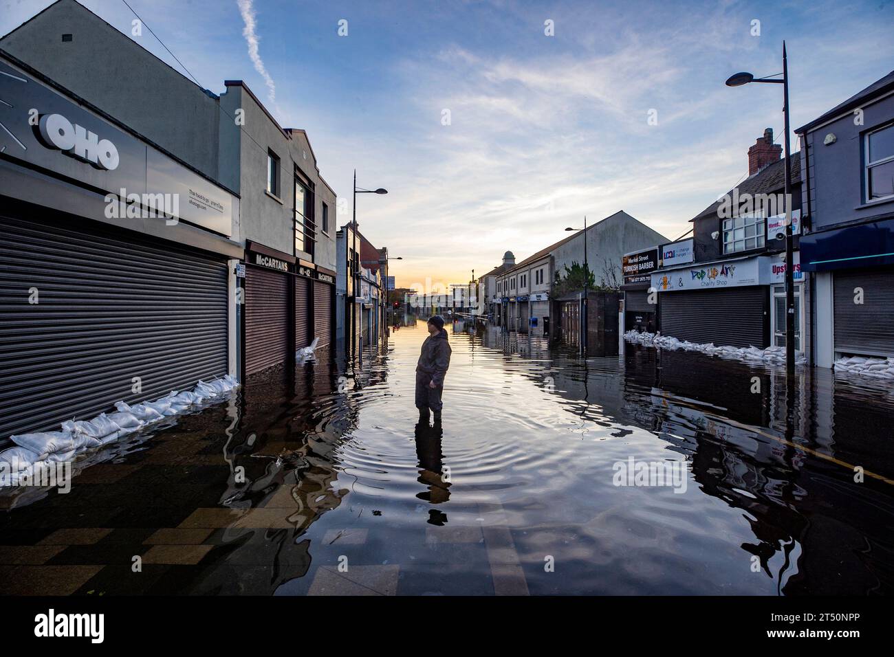 Michael McShane walks through flood water on Market Street in ...