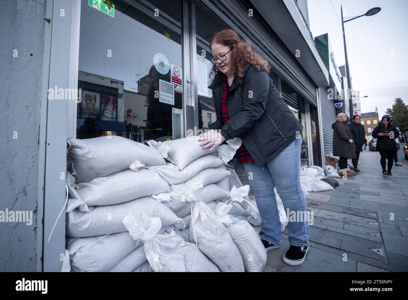 Marie Curie Downpatrick store manager Lisa Glackin stacks sand bags ...