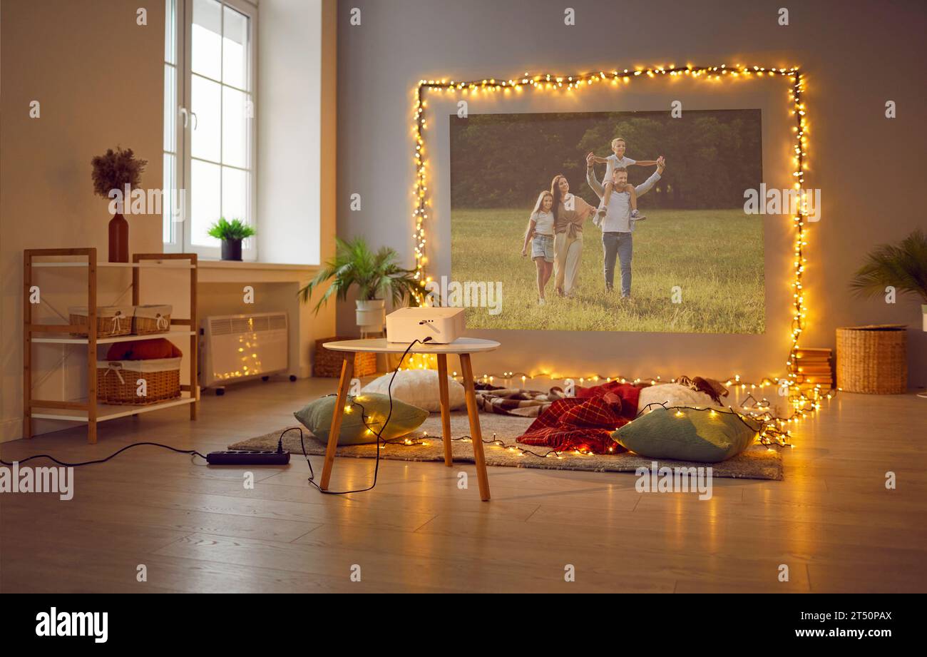 Living room interior with decorations, projector, family videos on wall ...