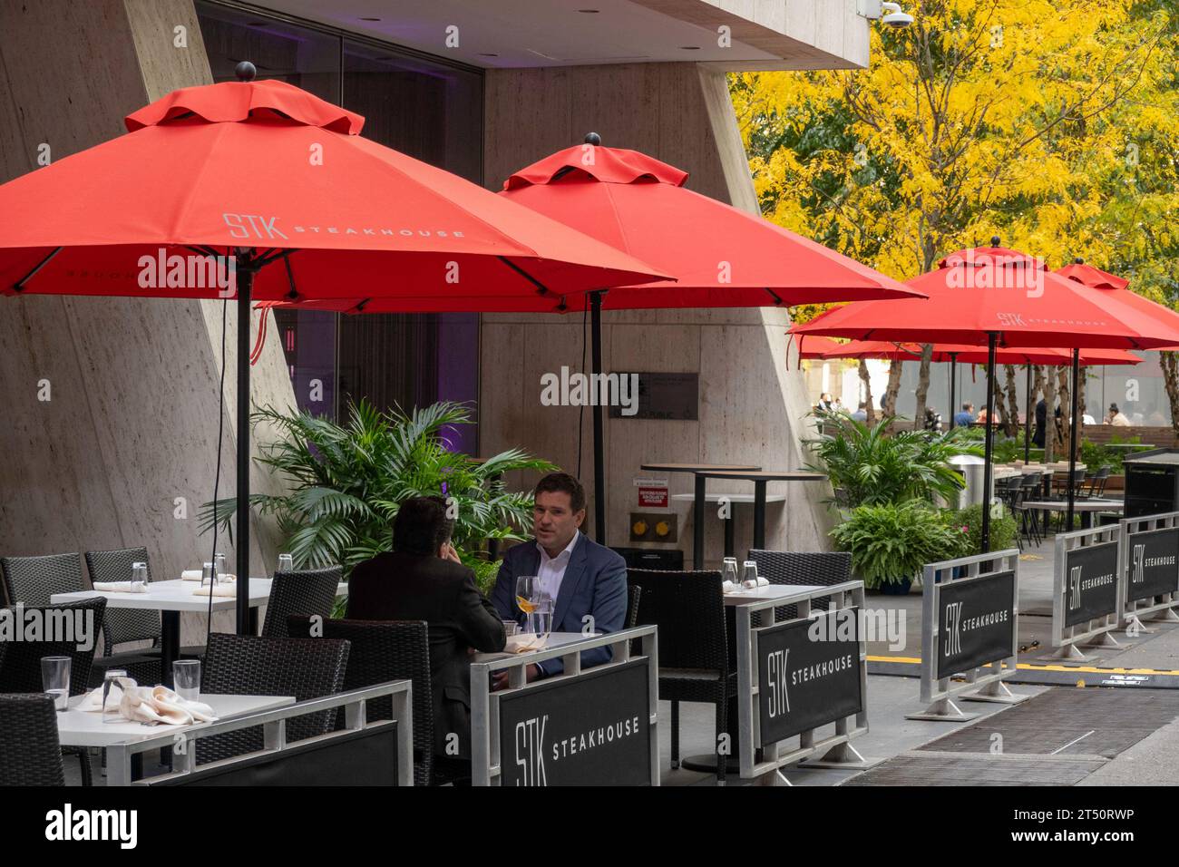 Business people enjoying lunch in an outdoor restaurant in Midtown ...