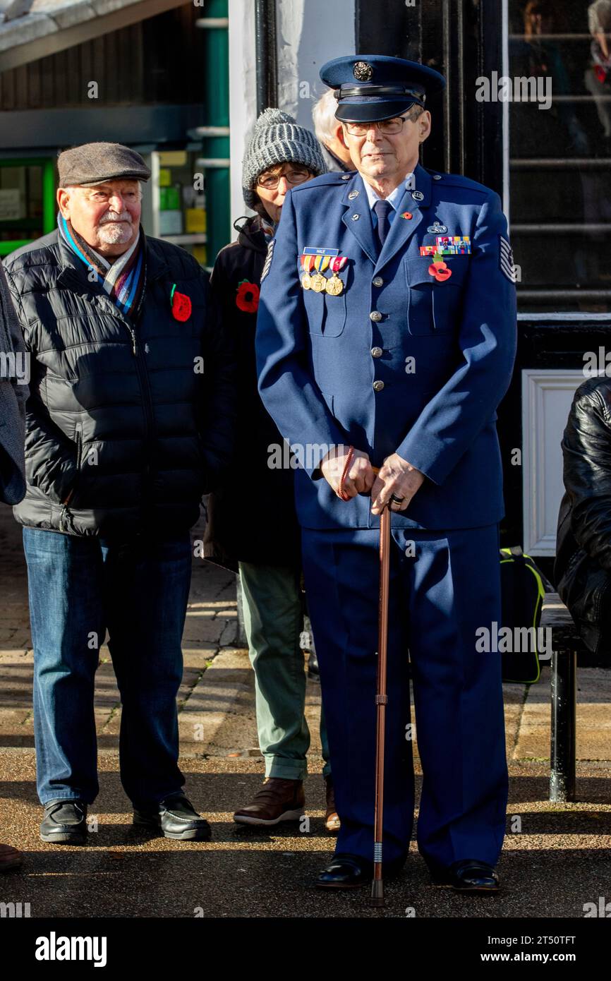 A veteran US airman in uniform and holding a walking stick stands by a ...