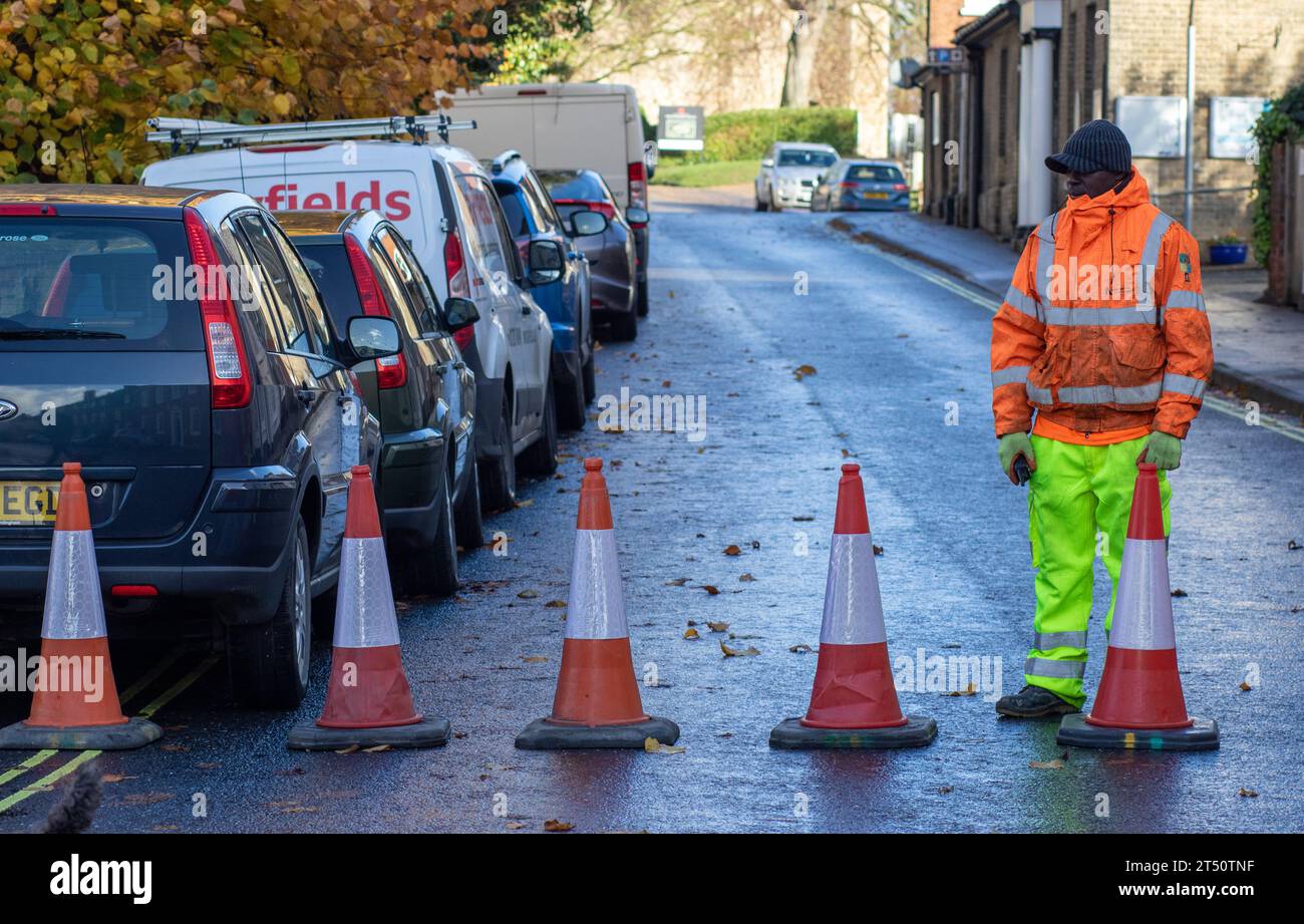 In a Suffolk market town a traffic management worker temporarily closes ...