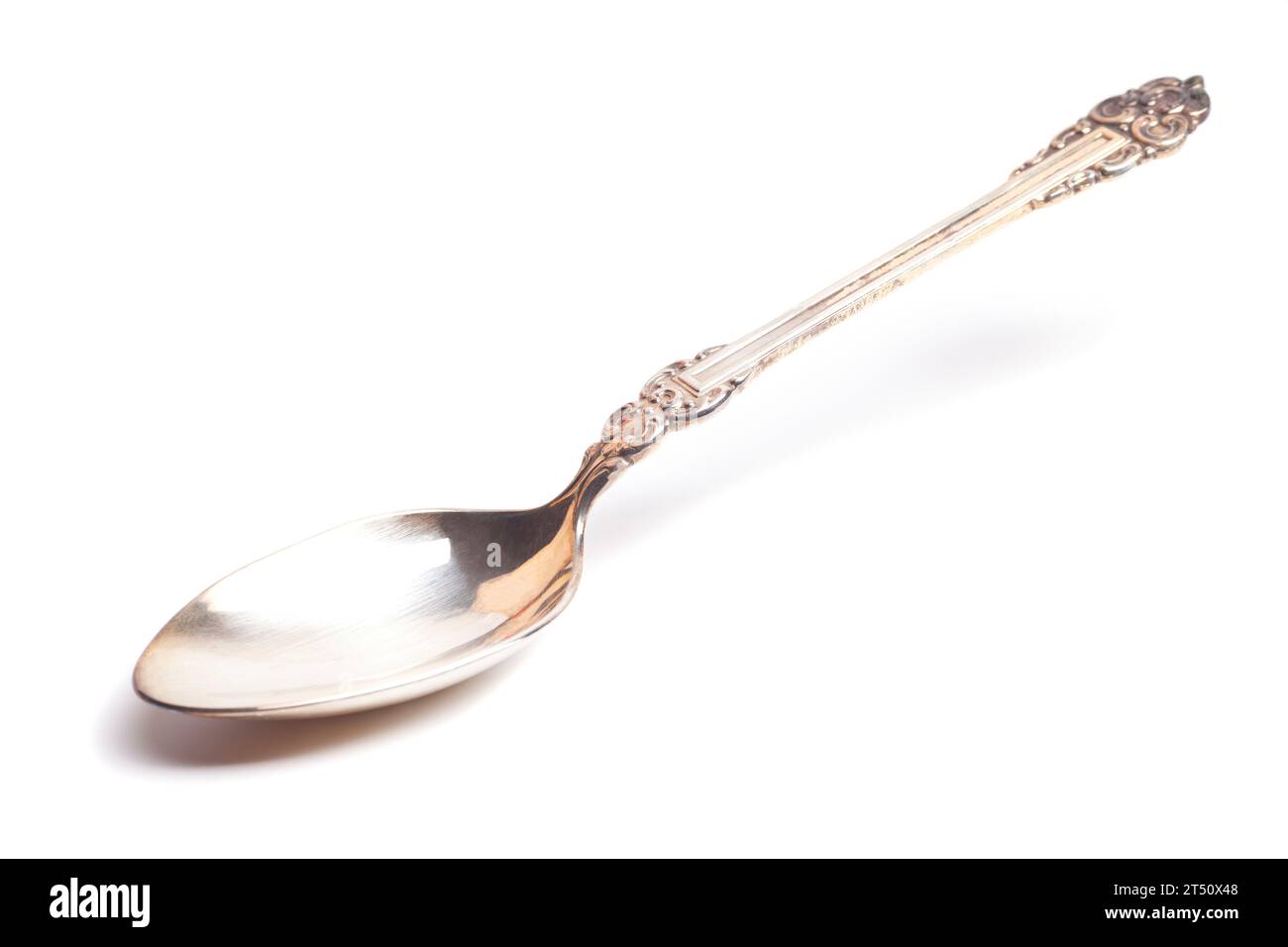 Old silver teaspoon with handle pattern isolated on white background ...