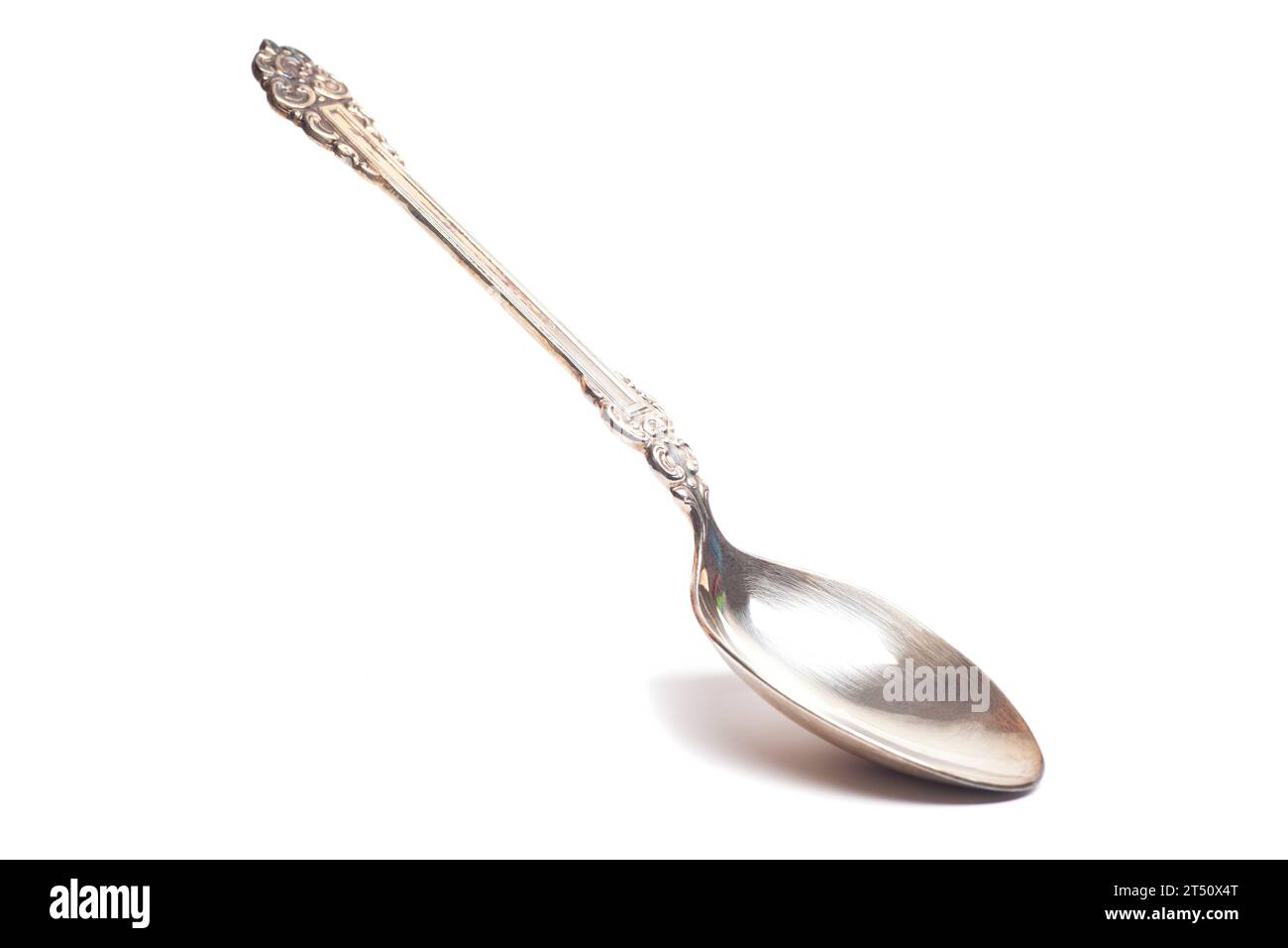 Old silver teaspoon with handle pattern isolated on white background ...