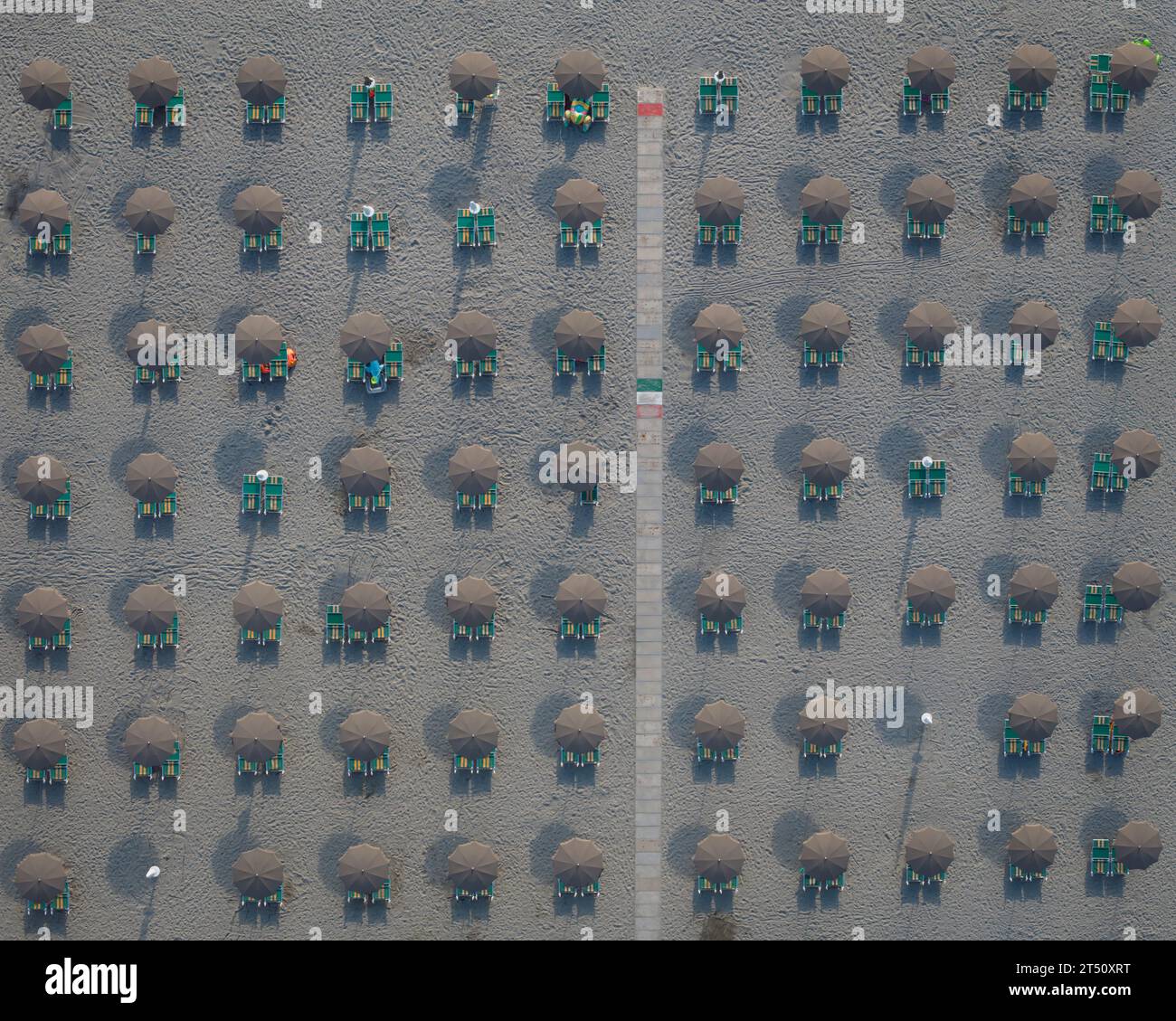 Aerial view of large group of tidy beach umbrellas, beach parasol shot ...