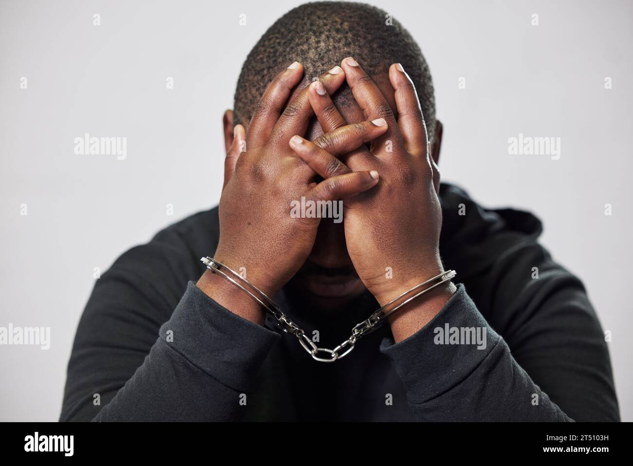 Handcuffs, arrested criminal and black man with stress, worry and ...
