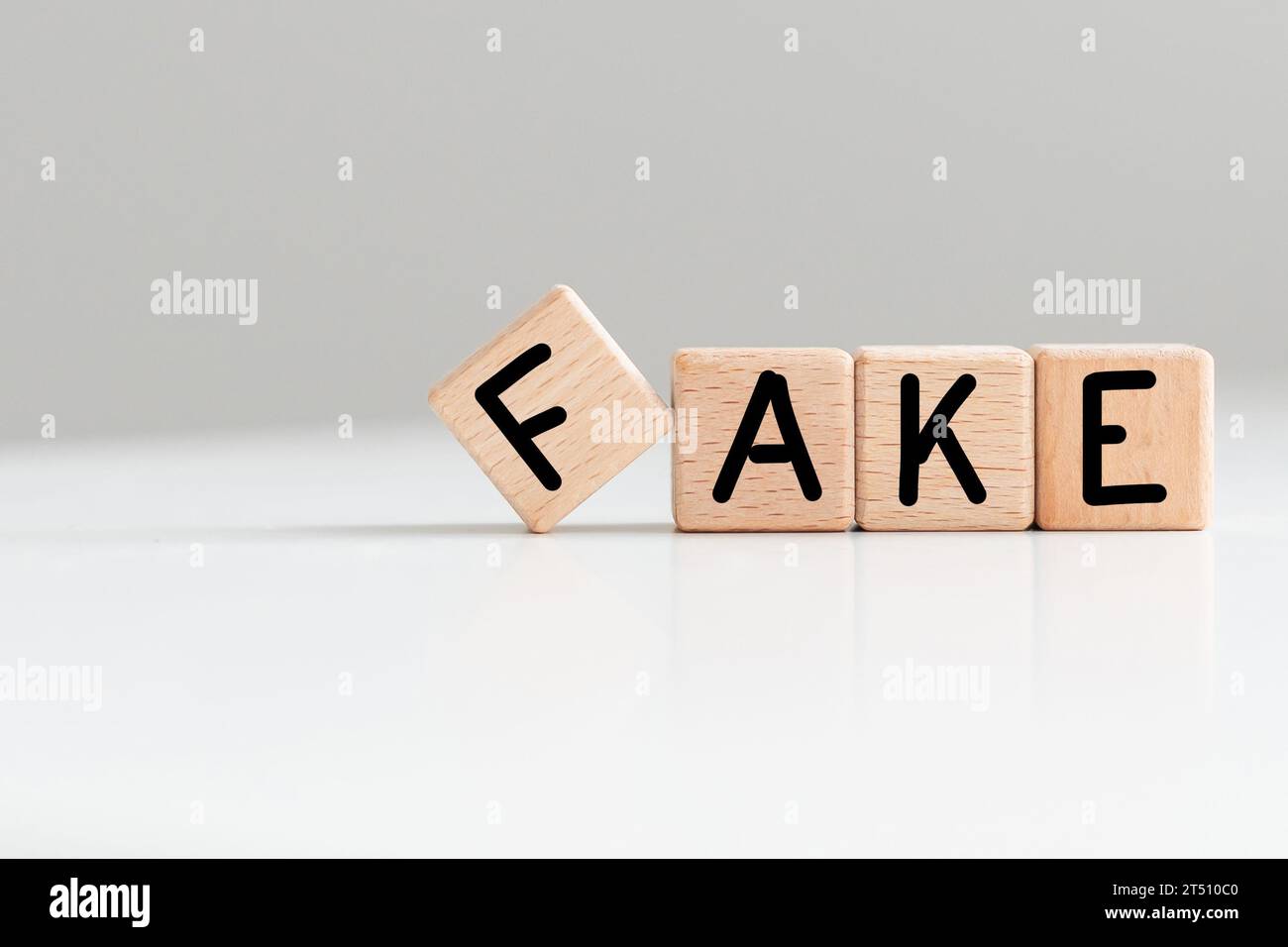 FAKE word written in wooden blocks on white background Stock Photo - Alamy