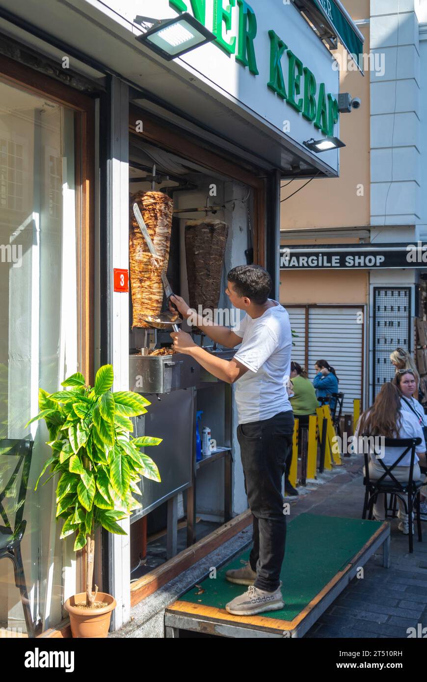 Istanbul, Turkey, A male employee cutting a kebab at a restaurant ...
