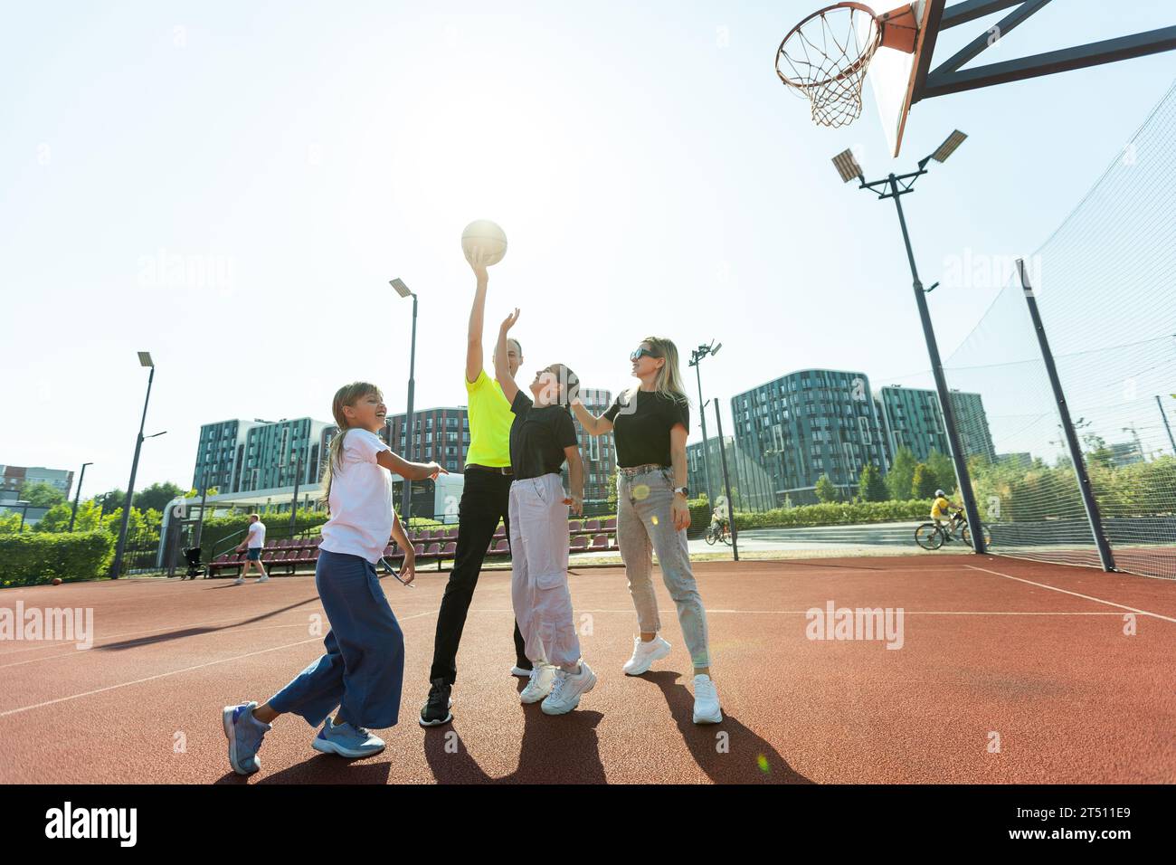 family playing basketball on court Stock Photo - Alamy