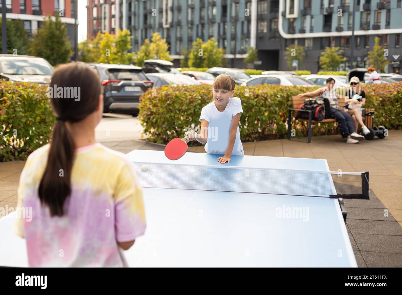 Little children playing ping pong in park Stock Photo - Alamy