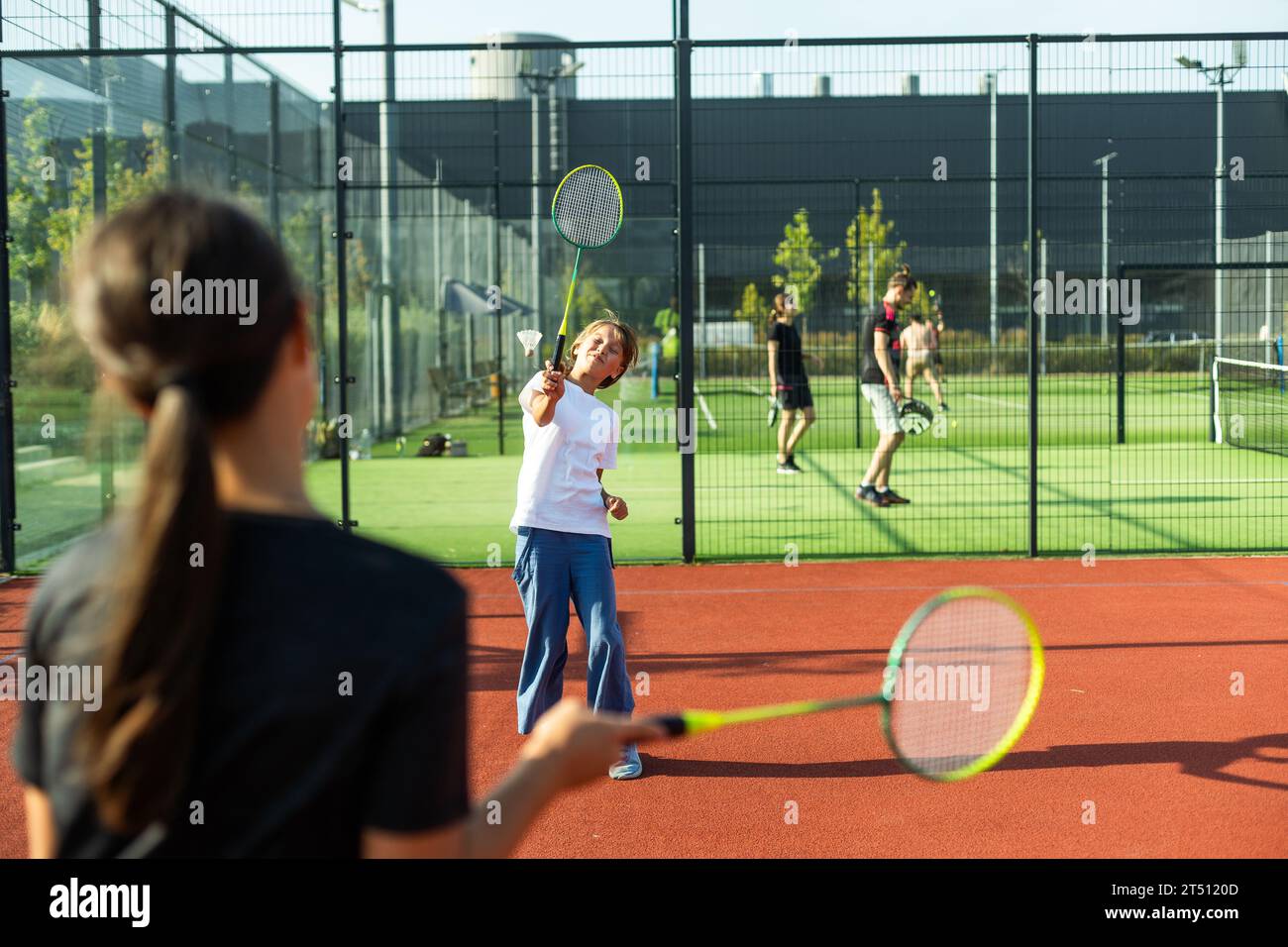 Two girls with badminton rackets on the football field Stock Photo - Alamy