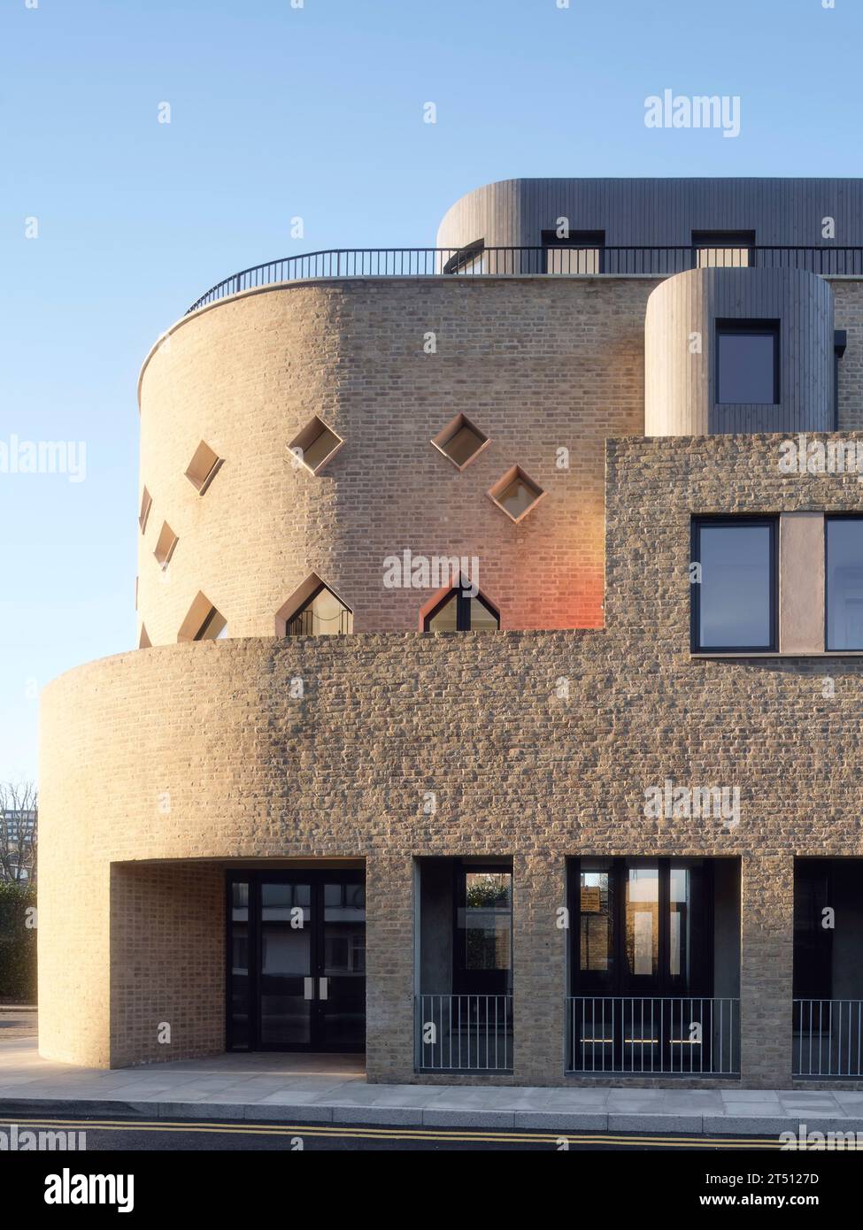 Street facade with ground floor entrance to community centre. The ...
