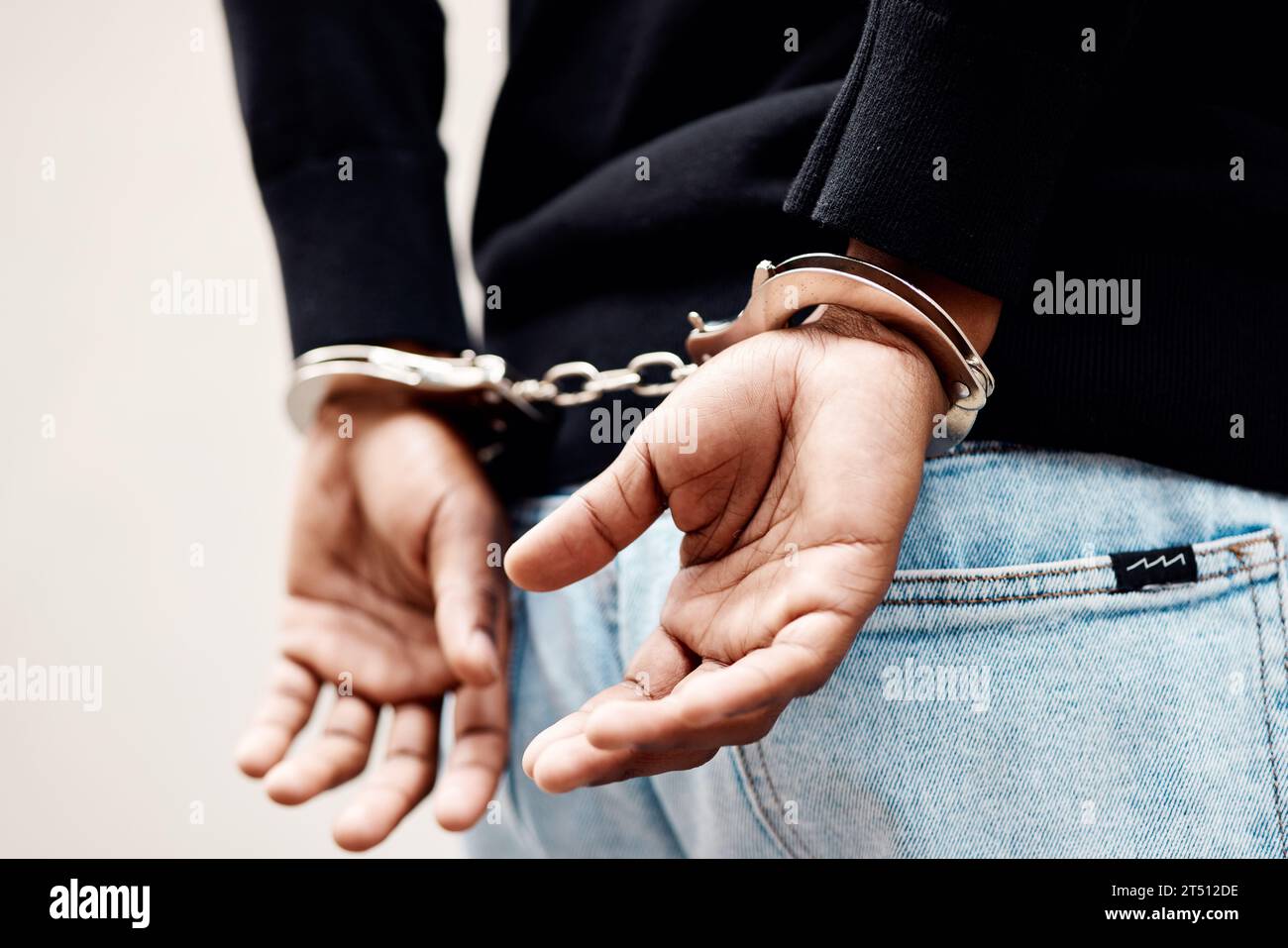 Handcuffed male police hi-res stock photography and images - Alamy