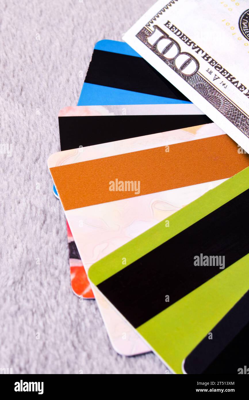 Dollar bill and bank cards on a gray background Stock Photo - Alamy