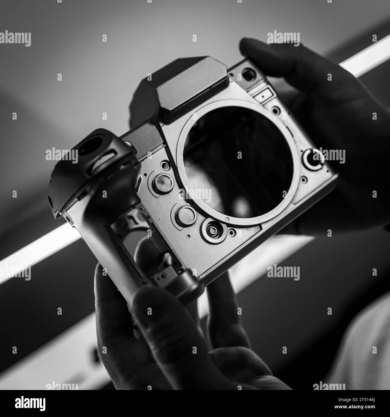 Engineer holding camera body in factory production Stock Photo - Alamy