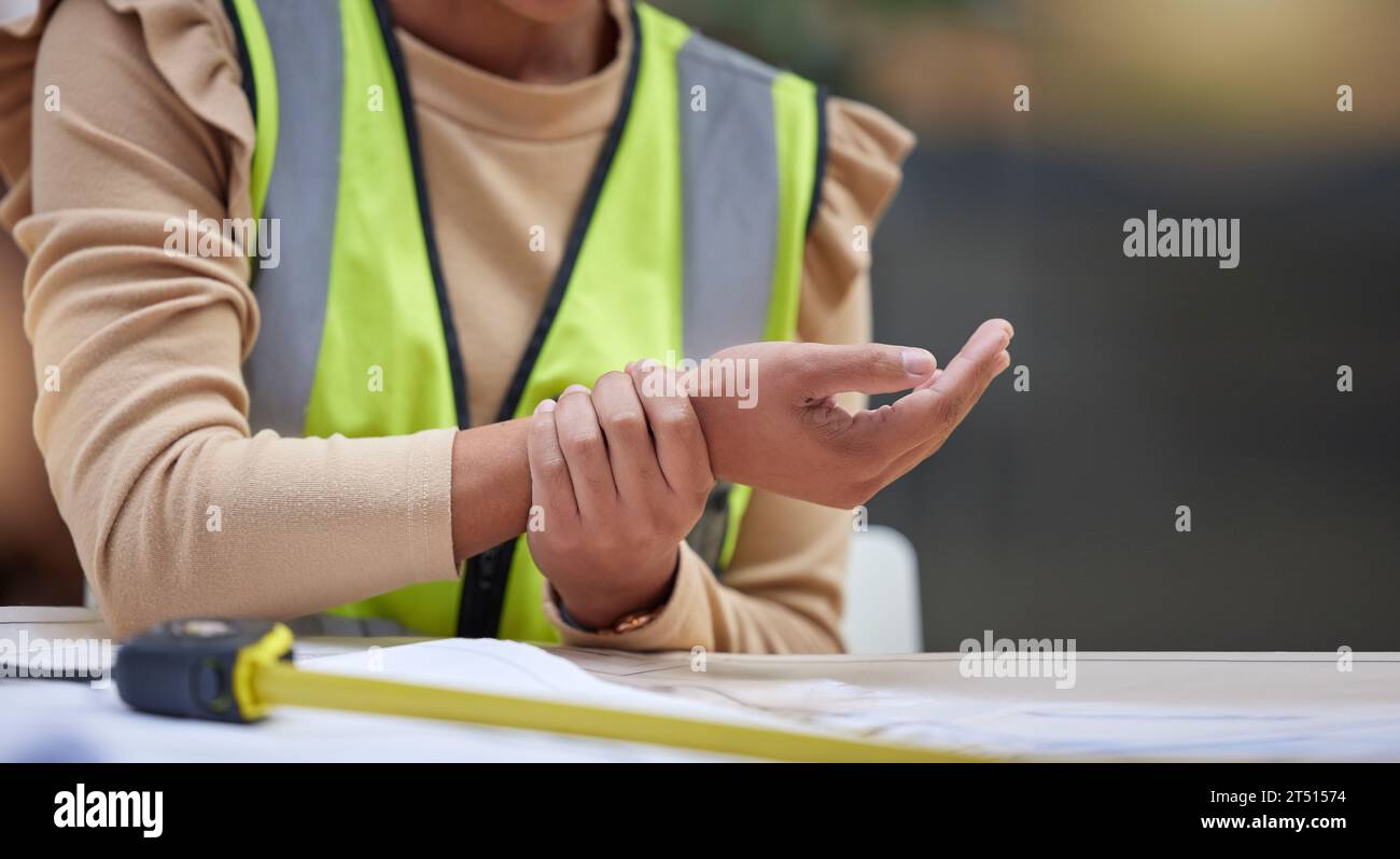 Industry, closeup and female construction worker with wrist pain ...