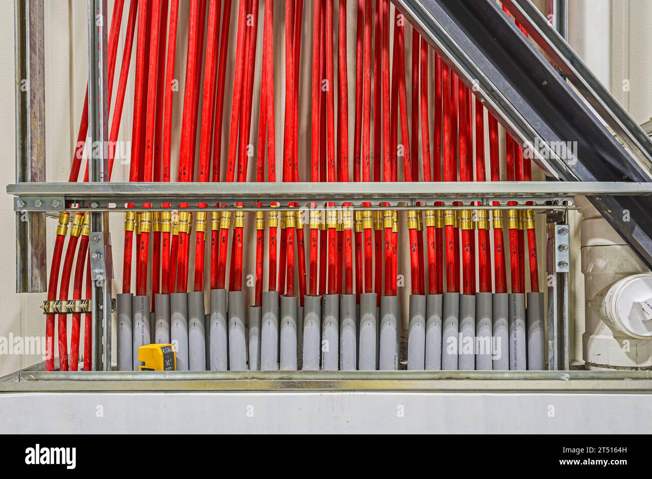 Closeup of red coolant hoses, with brass fittings, from the ceiling to ...
