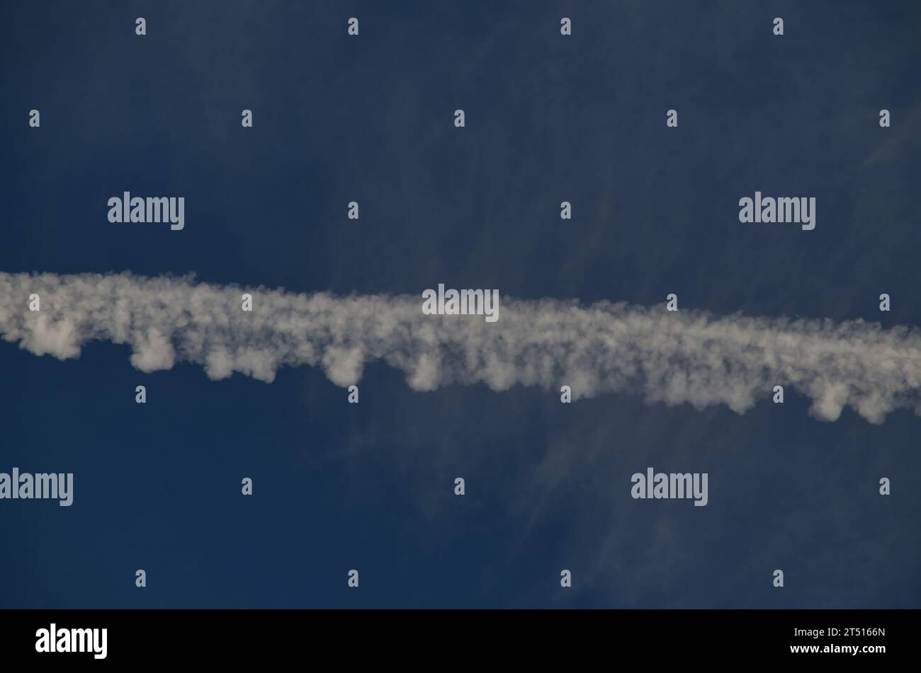 A white track, in the sky from a plane en route over the city of Sofia ...