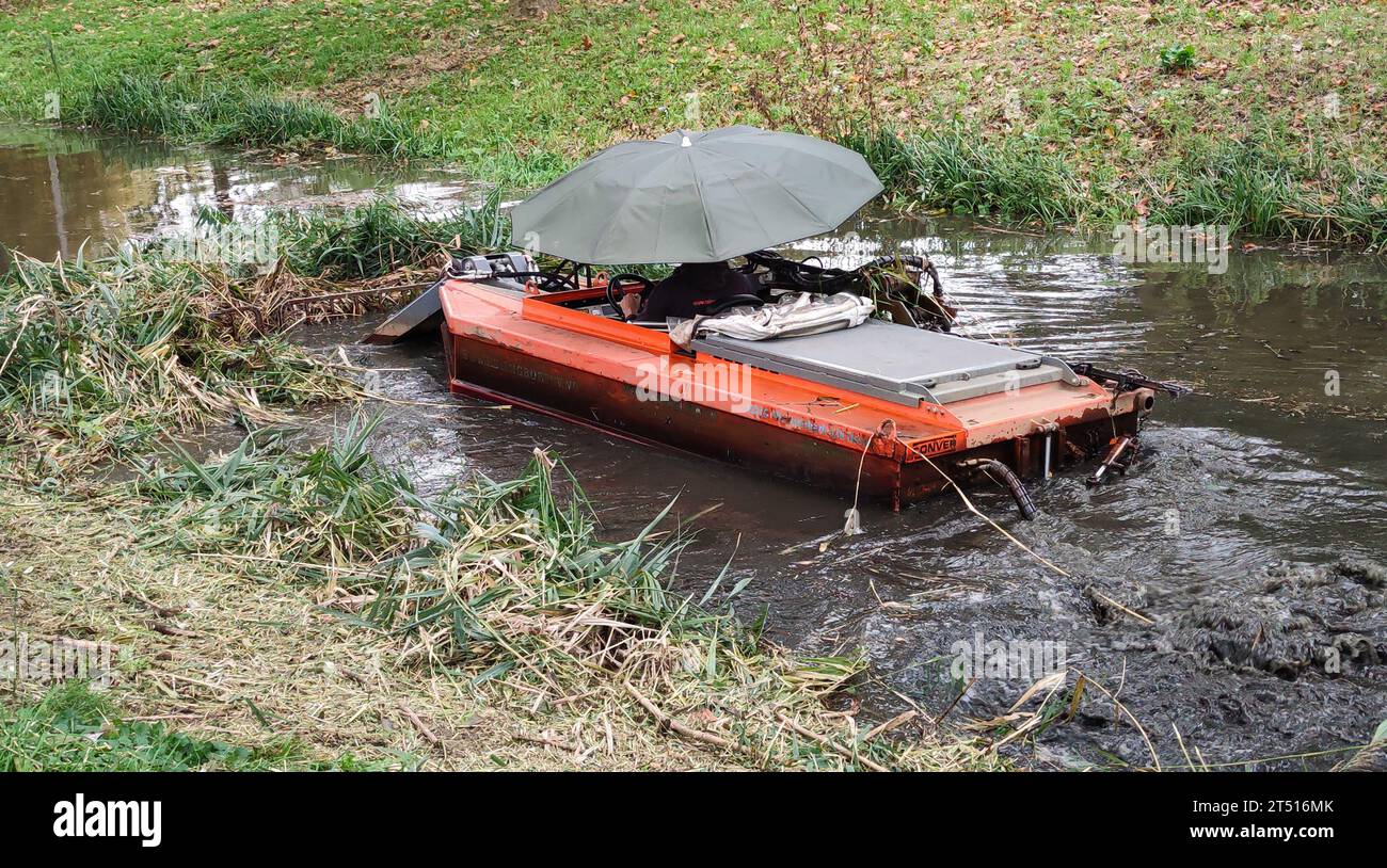 Dredging boat in a small canal Stock Photo - Alamy