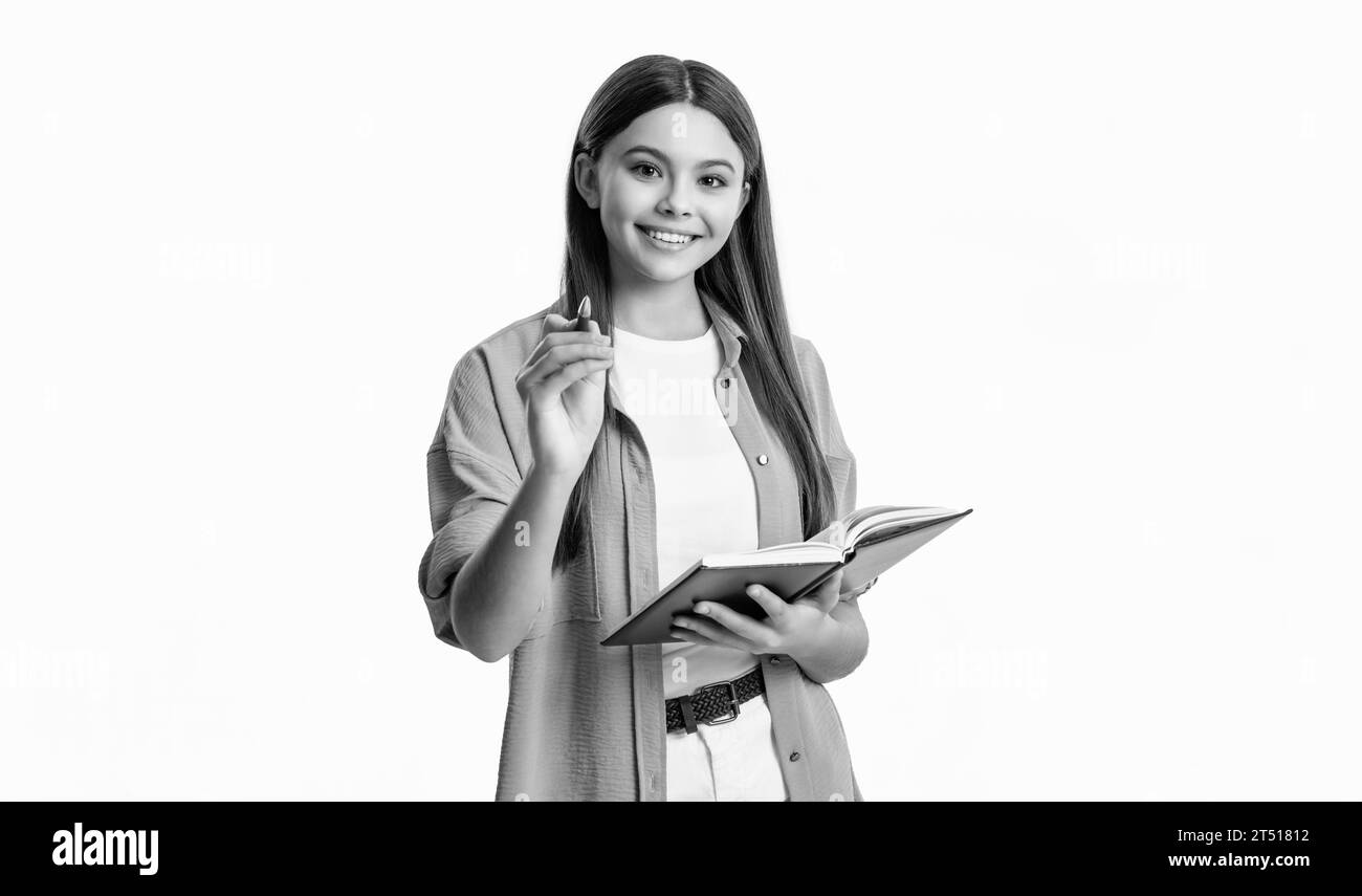 smiling teen girl noting school diary in studio. teen girl noting ...