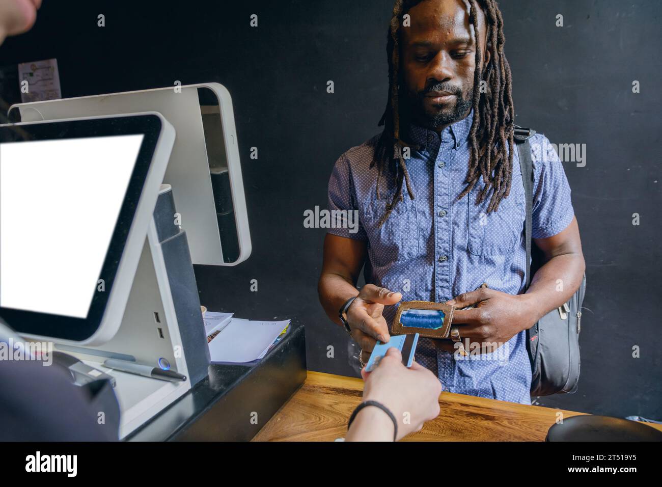 Black male customer of African ethnicity with dreadlocks and beard ...