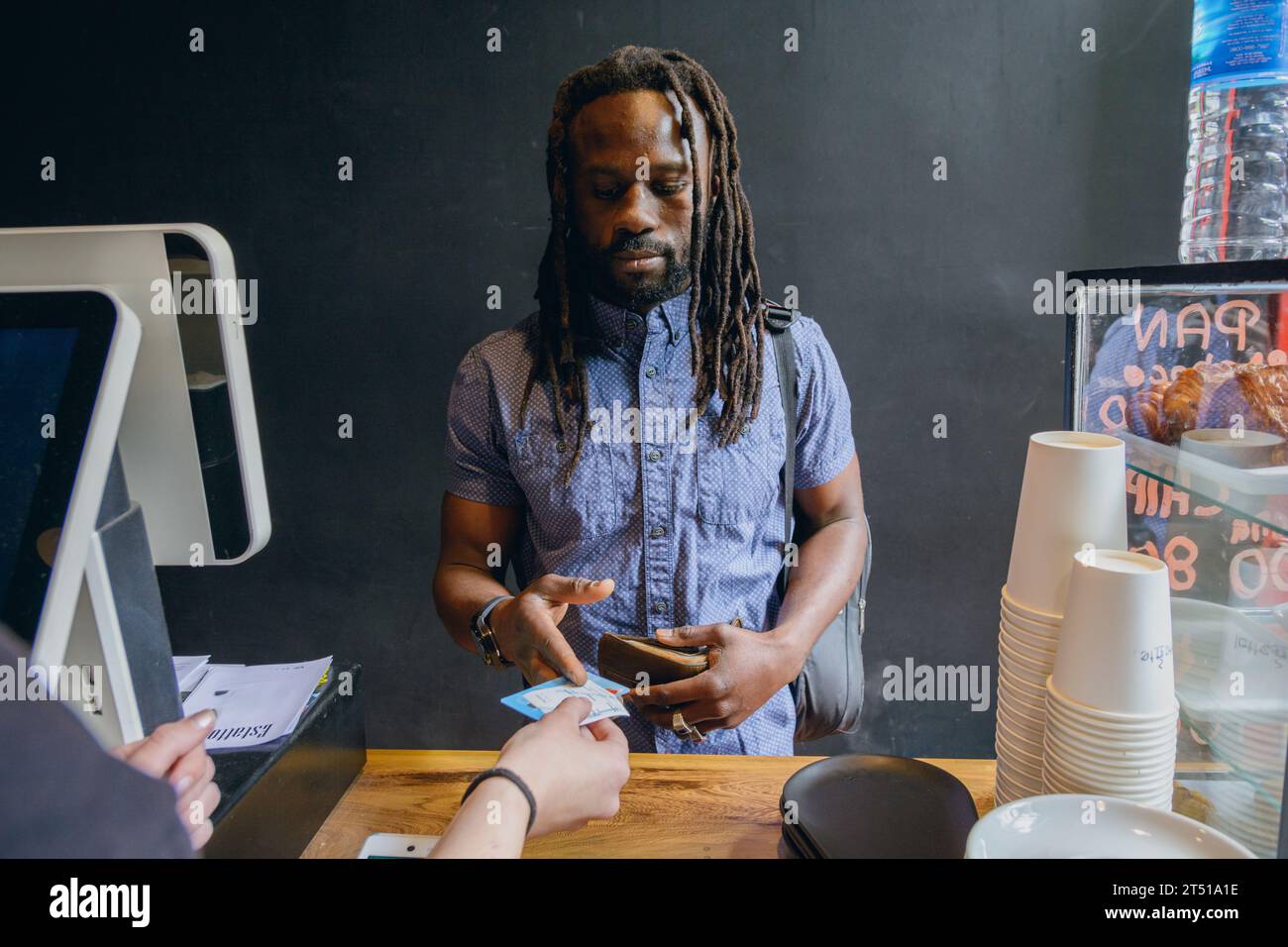 young black man with dreadlocks and beard standing in front of ...