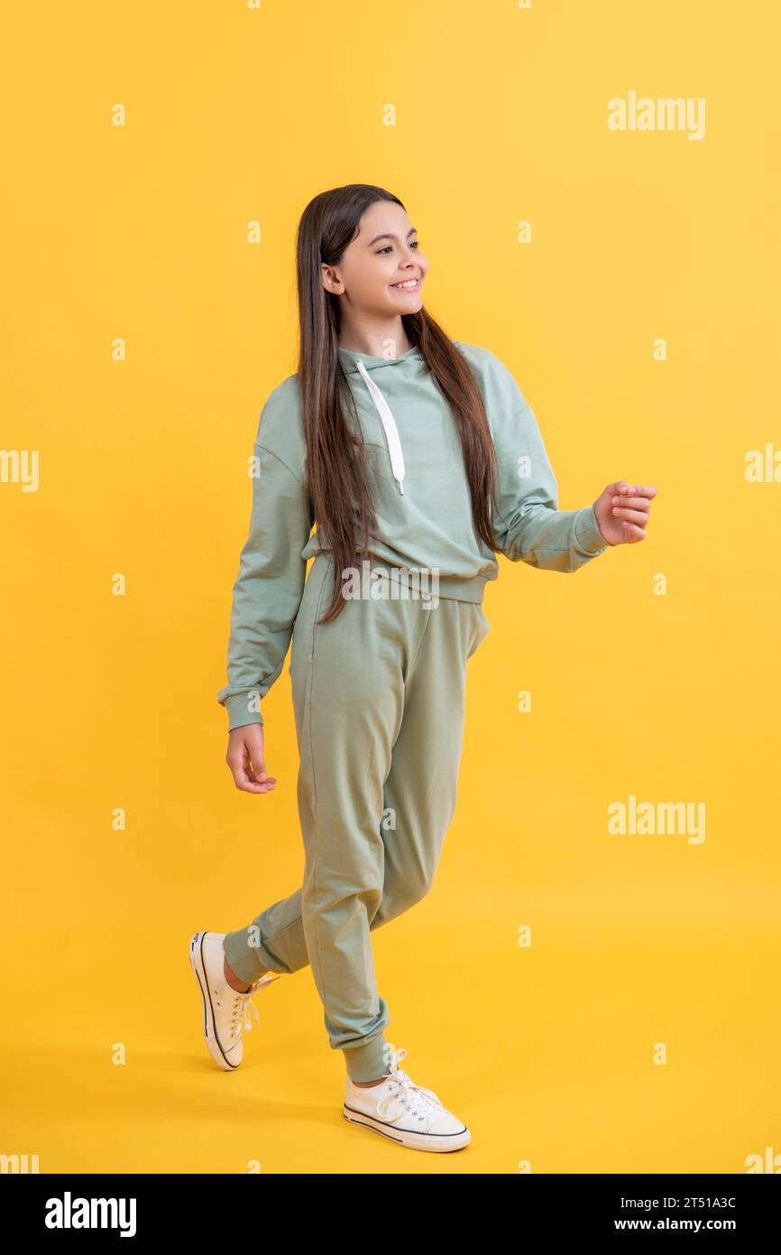 Energetic girl in a sportsuit go to sport gym having active childhood ...