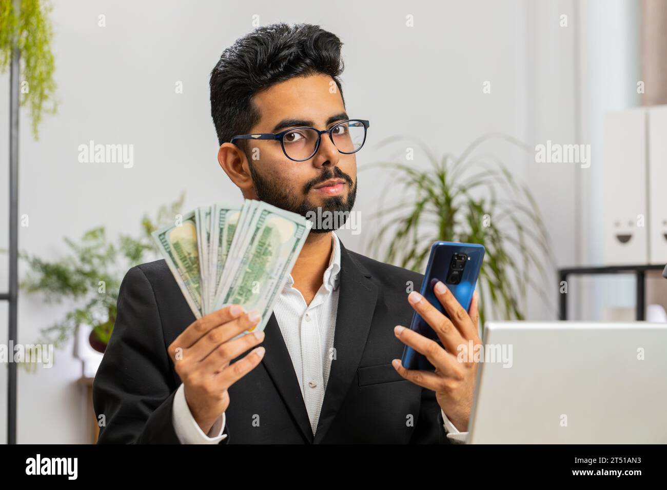 Happy rich Indian bearded businessman counting money dollar cash, use ...