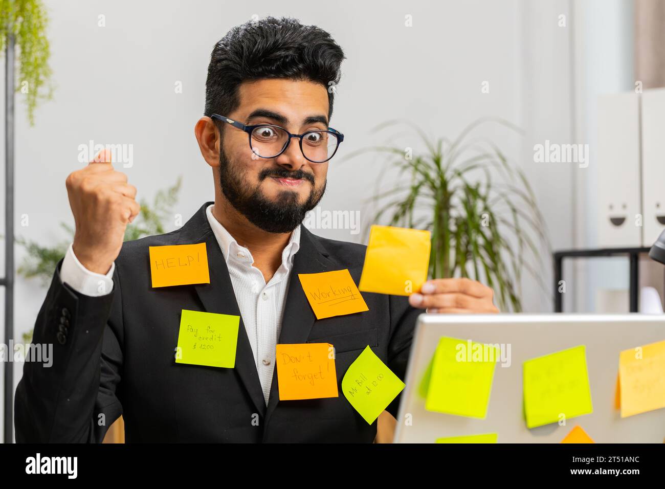 Tired exhausted Indian businessman working on laptop at office with ...