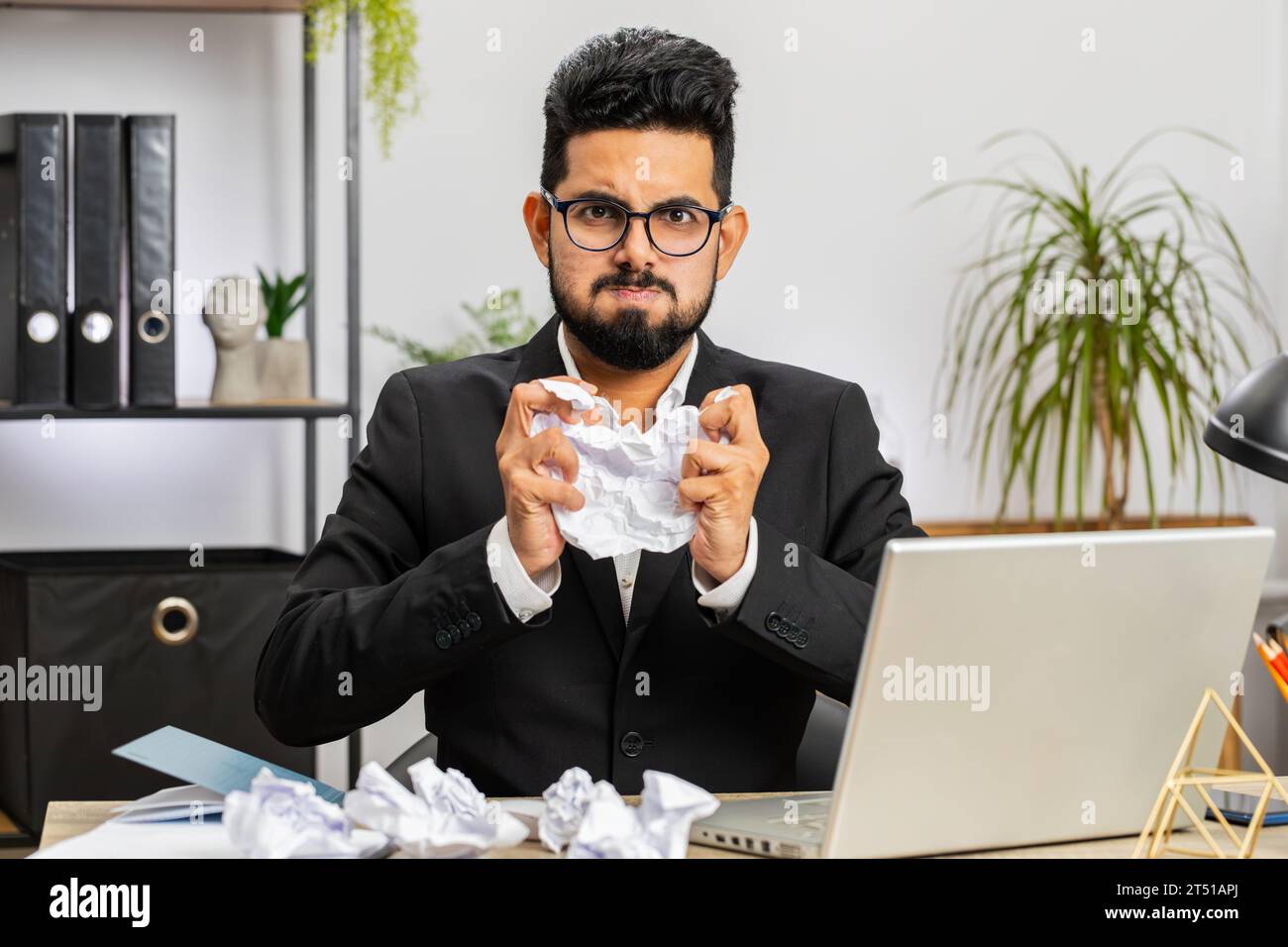 Angry furious Arab man working at office throwing crumpled paper ...