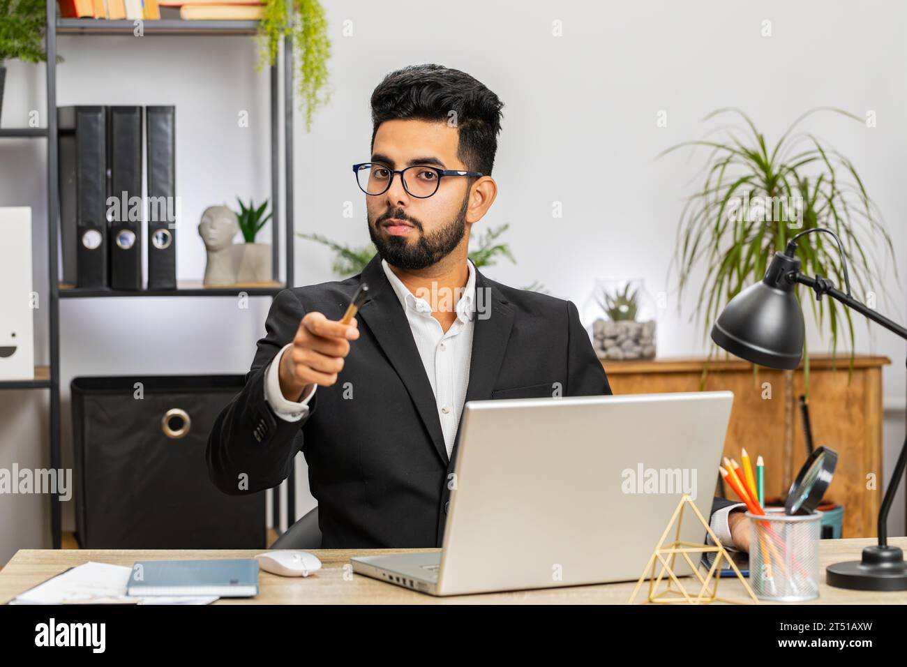 I choose you. Young Indian businessman programmer software developer working on office laptop ...