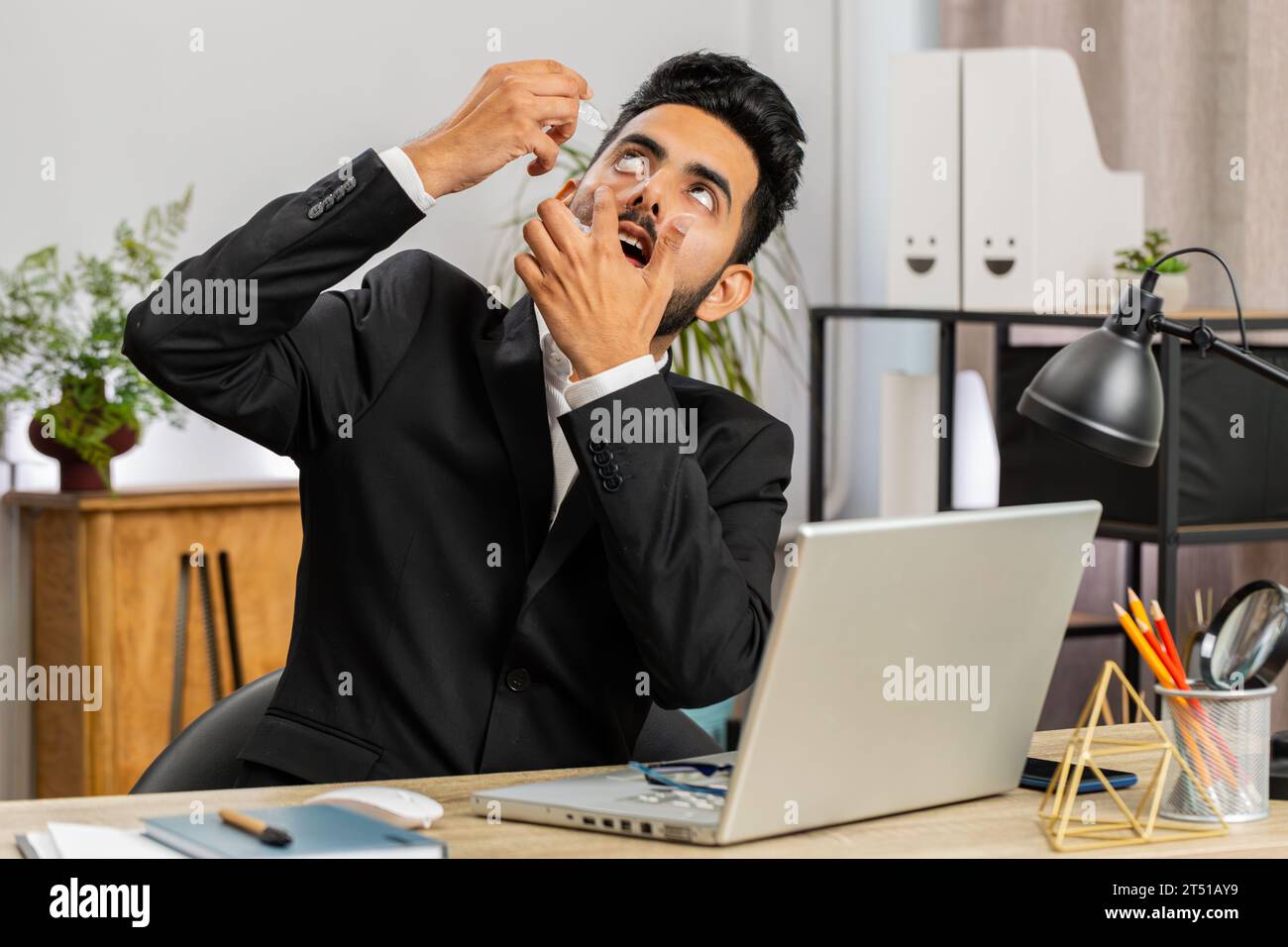 Sick Indian businessman freelancer suffering from eyes strain fatigue ...