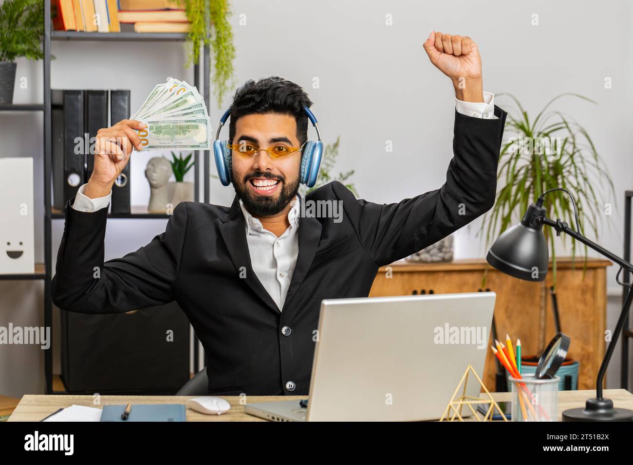 Indian businessman holding fan of cash money dollar banknotes celebrate ...