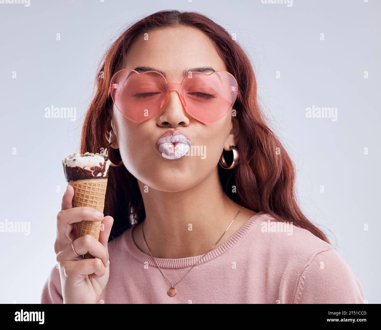 Kiss, ice cream and face of woman with sunglasses in studio with ...