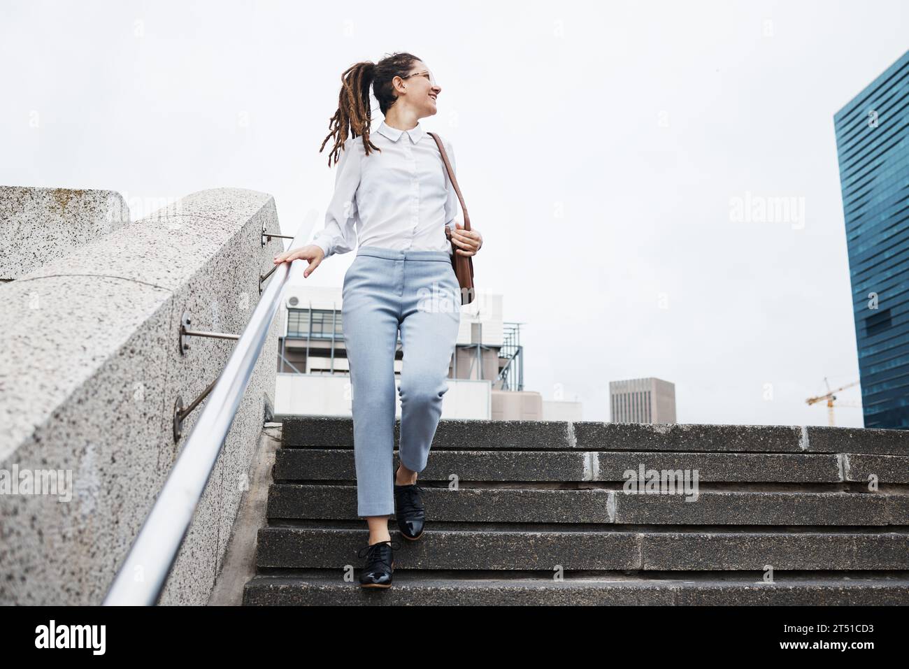 Business, woman and walking on city building steps happy, smile and ...