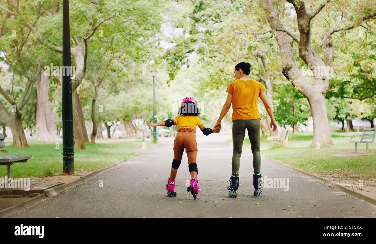 Mother, roller skates and child learning to skate at nature park for ...