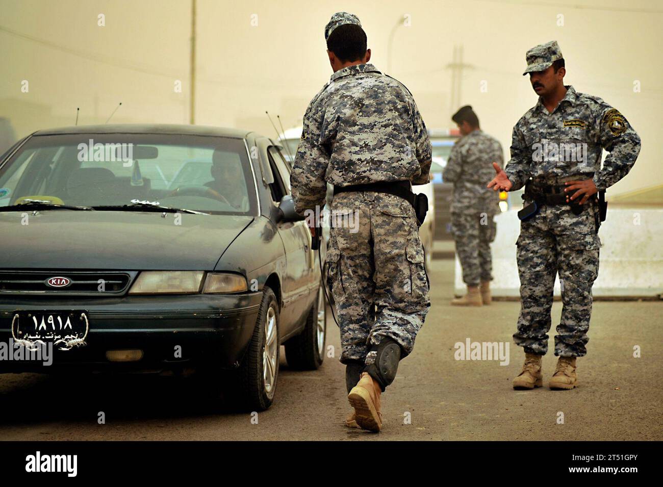 Iraqi soldiers and U.S. Soldiers hold random security checks during a ...