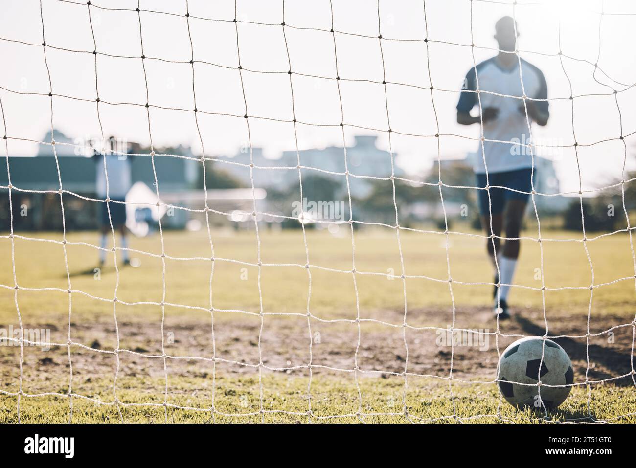 Sports, soccer and ball in net after goal, score and winning on field ...