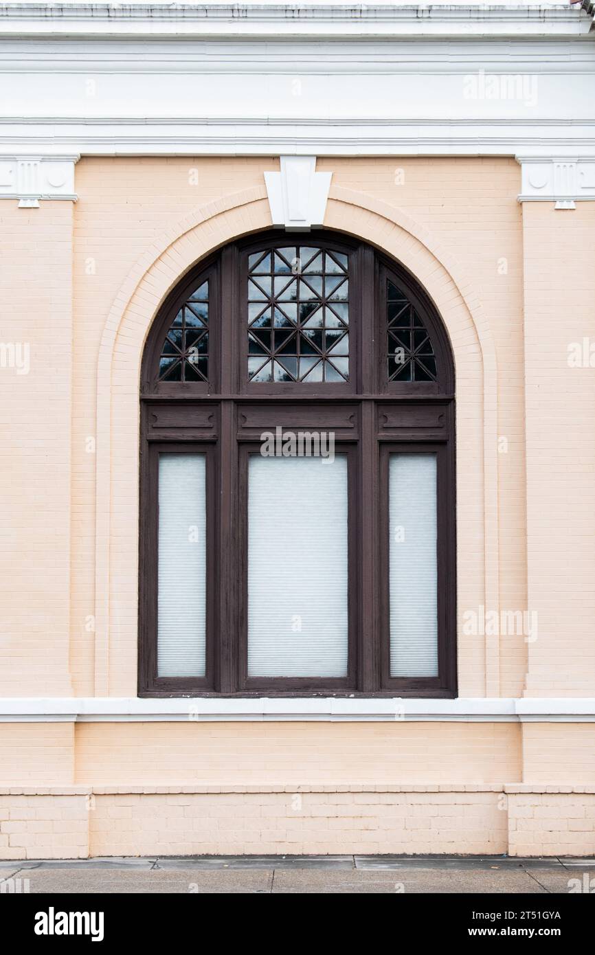 Decorative arched window of pink downtown bank building Stock Photo - Alamy