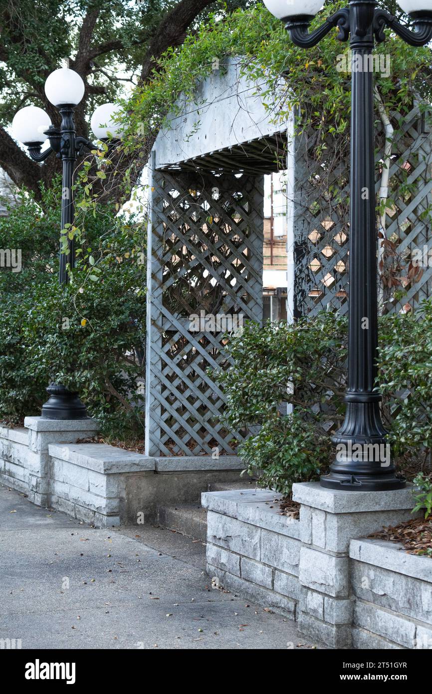 Lattice work entryway and lamp posts Stock Photo - Alamy
